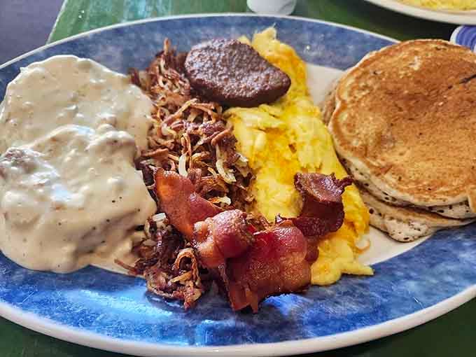Behold the breakfast plate that launched a thousand return visits: eggs, bacon, sausage, hash browns, and fluffy pancakes together.