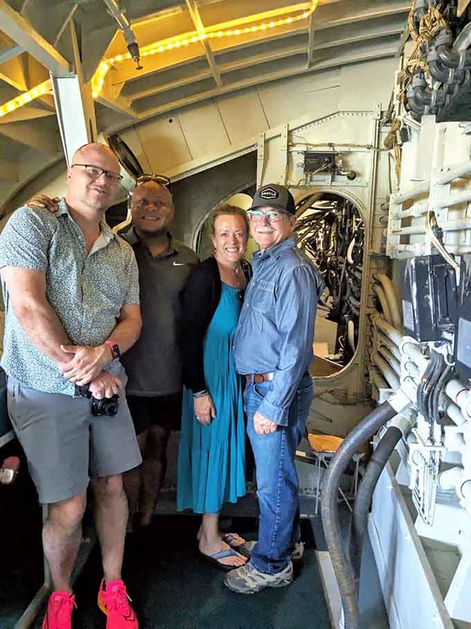 These smiling faces capture the pure joy of standing inside aviation history, surrounded by machines that changed everything.