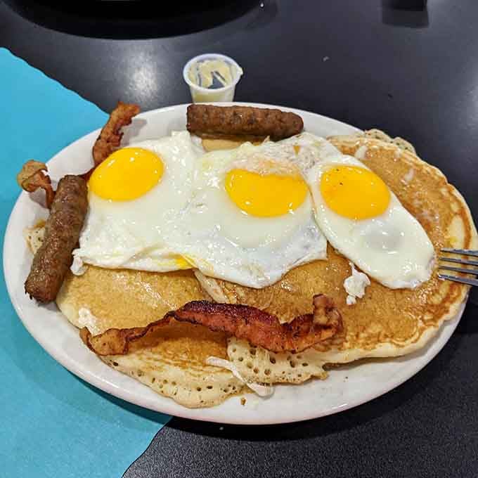 Three eggs, bacon, sausage, and pancakes the size of dinner plates: breakfast built for champions and hungry mortals alike.
