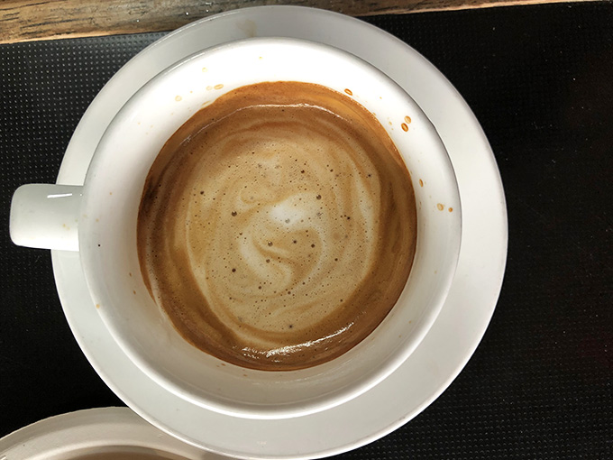 That swirl of foam on top is basically edible art, proving coffee can be beautiful and delicious simultaneously.