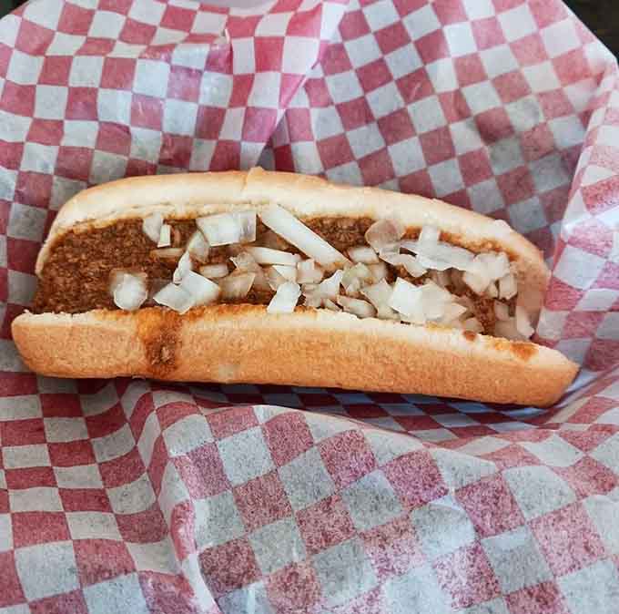 Behold the Coney Island hot dog: meat sauce, mustard, onions, and pure nostalgia wrapped in wax paper.