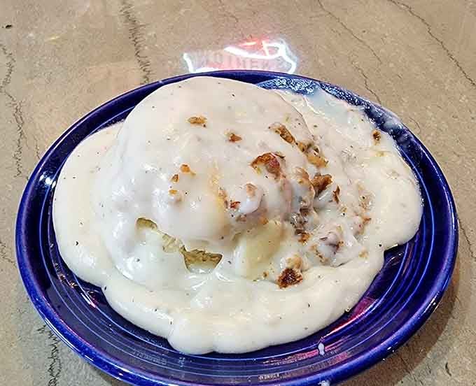 Biscuits drowning in creamy sausage gravy, the kind of comfort food that makes mornings worth waking up for.