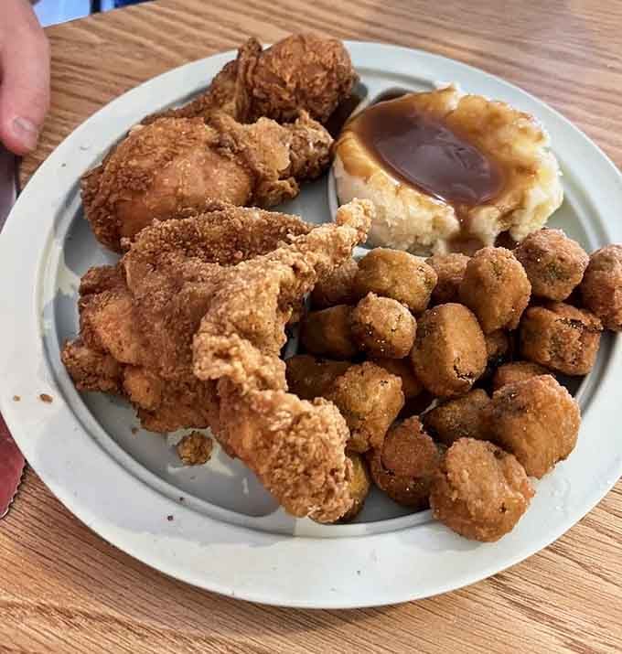 Golden fried chicken, crispy hush puppies, and a side of gravy that could make a vegetarian reconsider their life choices.
