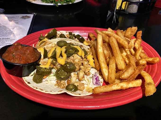These aren't just tacos; they're edible Alaskan postcards. Blackened halibut nestled in flour tortillas with crisp toppings and a side of perfectly golden fries.