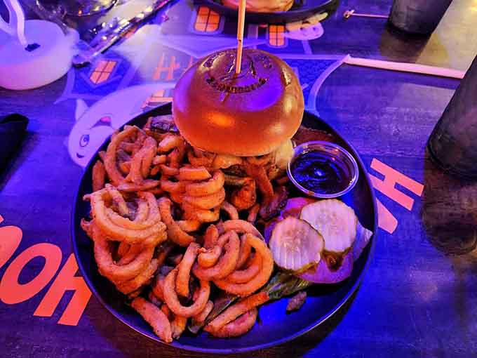 Behold the Tarantula burger, crowned with a golden bun and surrounded by enough curly fries to feed a small army.