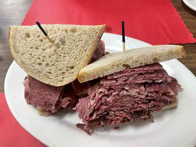 Behold the pastrami tower that makes you question the structural integrity of rye bread and your own jaw.