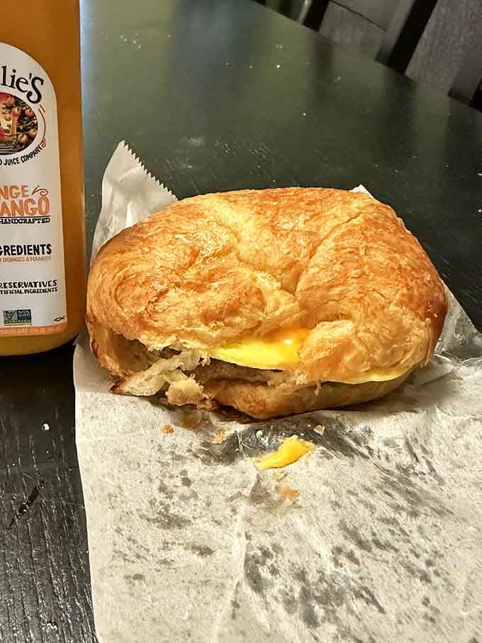 Behold the croissant breakfast sandwich, where buttery layers meet eggs and sausage in beautiful, messy harmony.