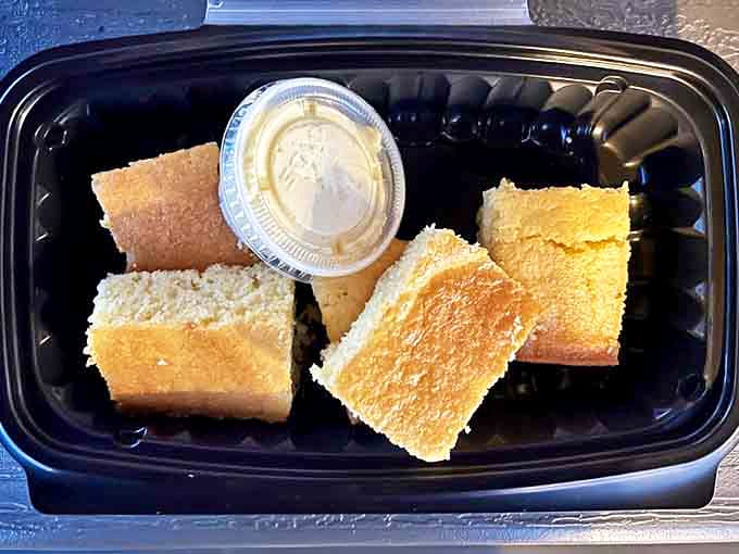 Golden cornbread squares arrive with a side of honey butter &ndash; the kind of simple pleasure that makes you question why you'd ever waste stomach space on salad.