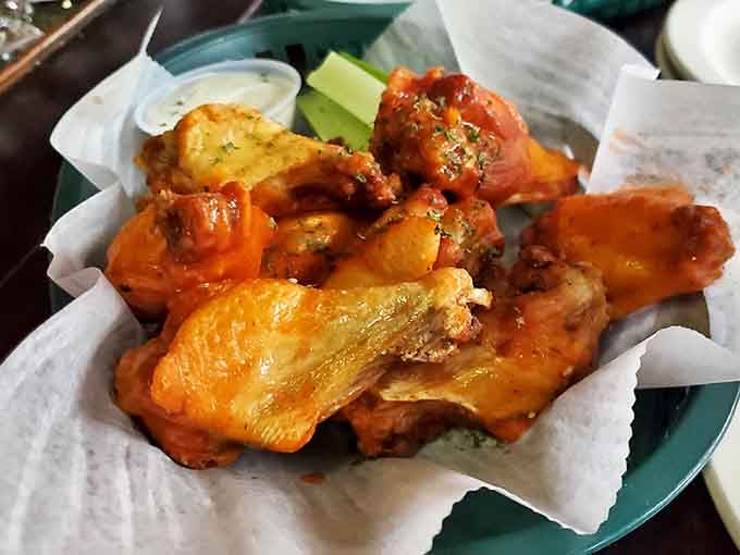 Golden wings glistening with sauce, served with celery and blue cheese, the bar food gods smiling down.