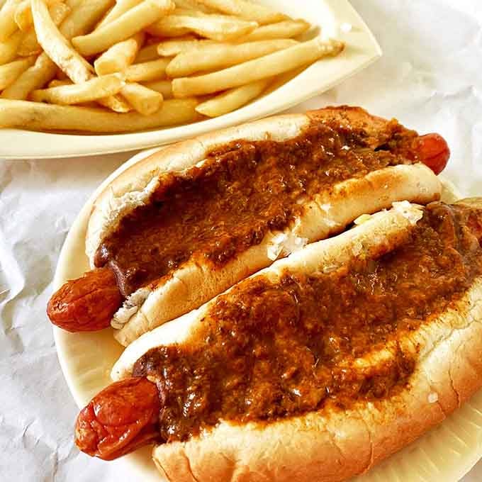 Two deep-fried beauties drowning in chili sauce, proving that excess is sometimes exactly what the doctor didn't order.