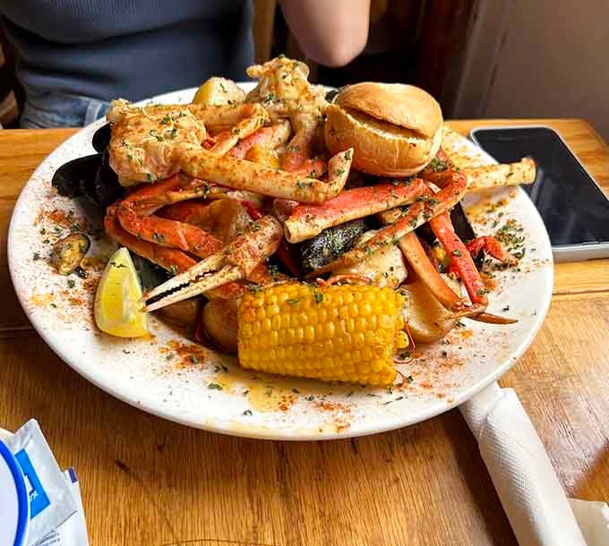 Crab legs, corn, and potatoes piled high like a treasure chest from the Atlantic just opened.