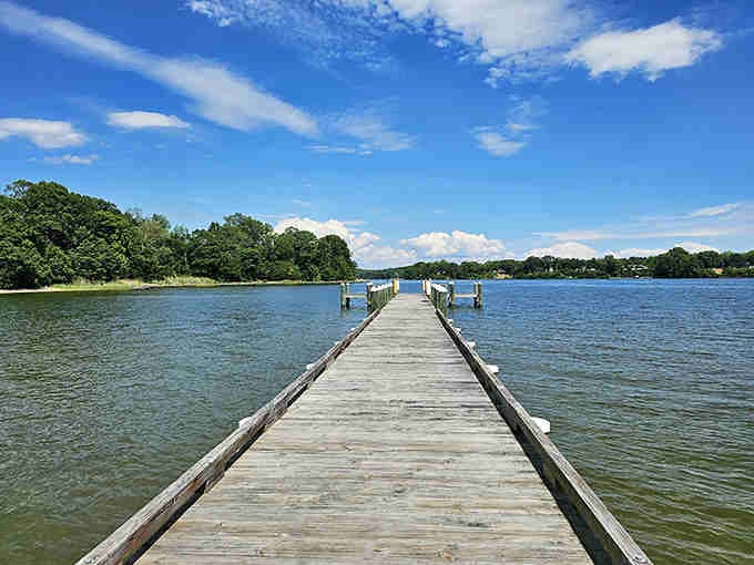 A wooden pier stretching into the Patuxent River, inviting you to walk where countless generations have gazed across these waters.