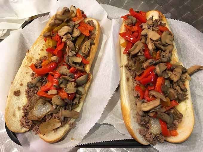 Two beauties loaded with peppers and mushrooms, proving that vegetables absolutely belong on a proper cheesesteak.