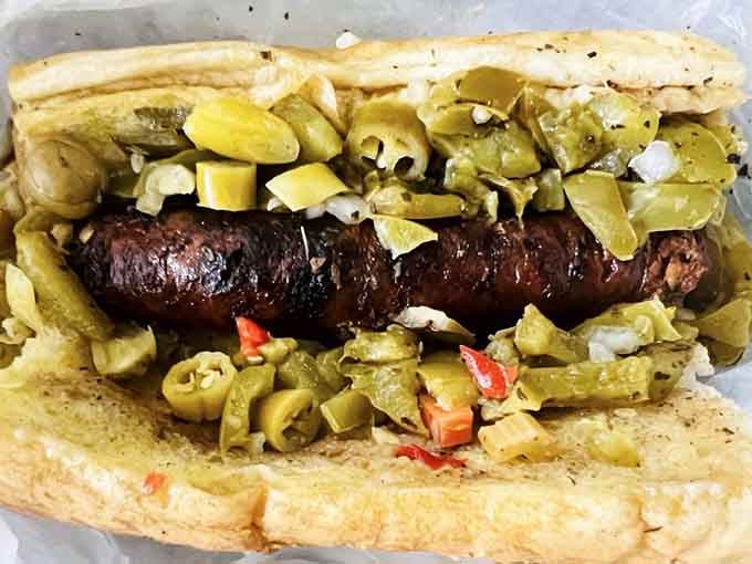 That charcoal-broiled sausage nestled in peppers proves sometimes the simplest combinations create the most memorable meals.