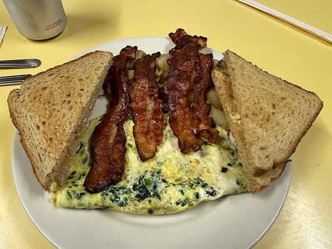 Bacon so perfectly crispy it practically sings, paired with an omelet that understands the assignment completely.