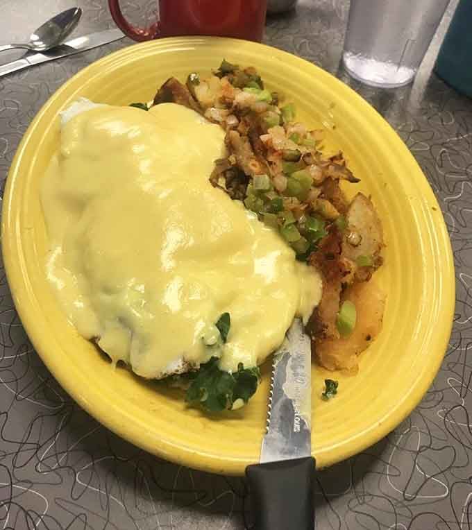 Hollandaise cascades over eggs like a creamy waterfall, turning breakfast into the kind of art museums should display.