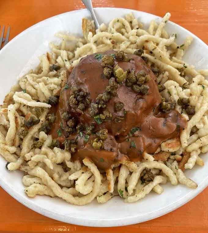 That German meatball sitting on sp&auml;tzle looks like it just won the lottery and wants to share its fortune.