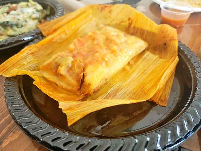 Behold the tamale in its natural habitat, still wrapped in corn husks like a delicious gift.