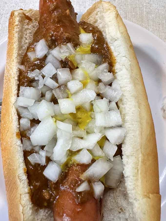 Behold the Detroit coney in all its glory: all-beef frank, meaty chili, yellow mustard, and diced onions perfection.