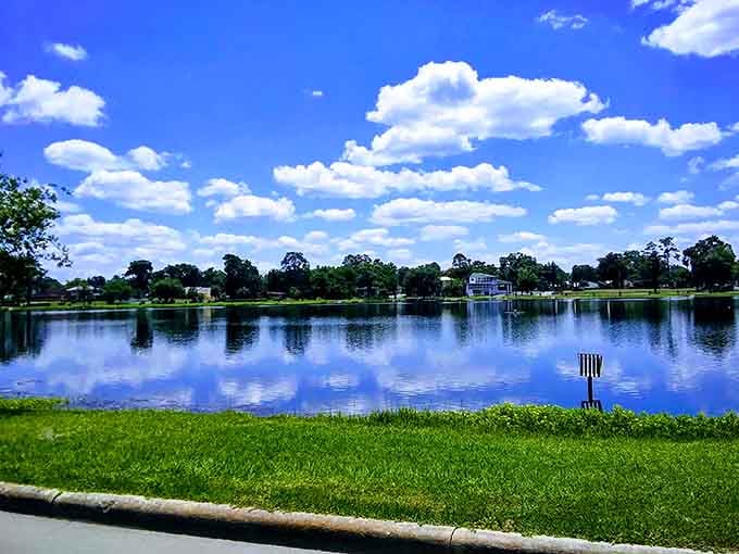 Lake De Soto reflects blue skies and green shores, offering waterfront views without requiring a second mortgage to enjoy them.
