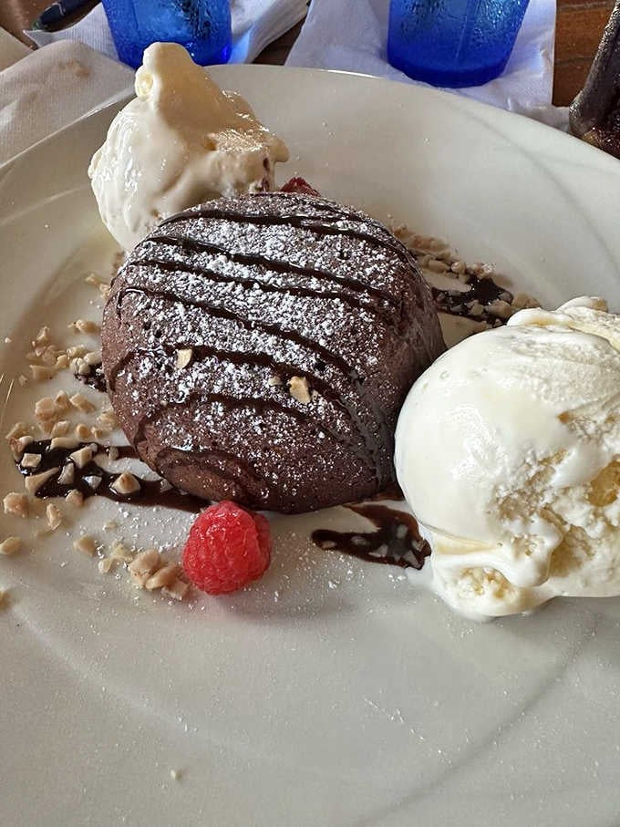Behold the legendary Hot Chocolate Lava Cake, where powdered sugar snow meets molten chocolate magma in a dessert that's worth the wait.