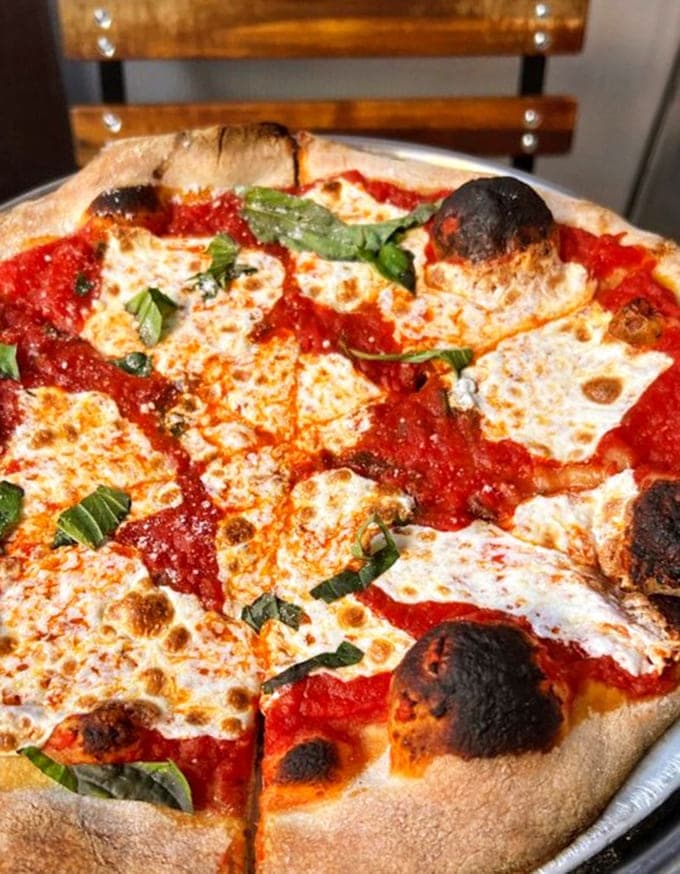 Those charred spots on the crust are like pizza's beauty marks &ndash; proof of a coal oven's kiss.
