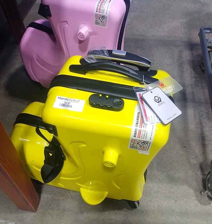 Bright yellow luggage waiting for its next adventure—proof that your travel companion doesn't need to be as expensive as your plane ticket.