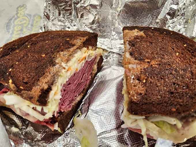 Dark rye bread hugging tender corned beef and melted cheese, this is what sandwich dreams are made of, literally.