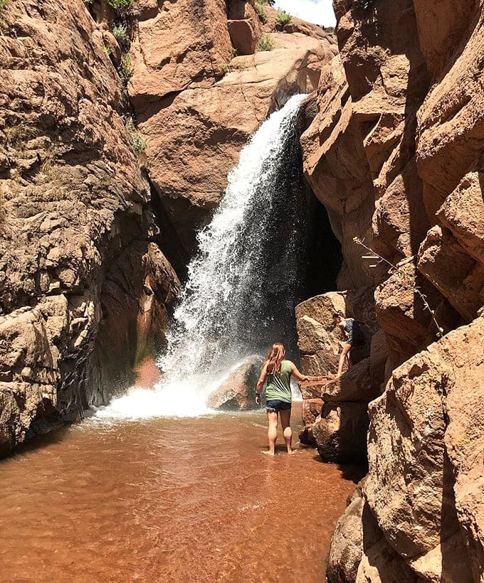 Hidden waterfalls tucked into red rock canyons offer the kind of refreshing surprise that makes exploration worthwhile.