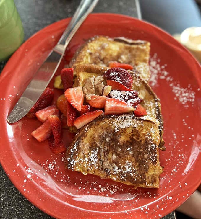 French toast topped with fresh strawberries and powdered sugar, because sometimes simple perfection needs no explanation whatsoever.