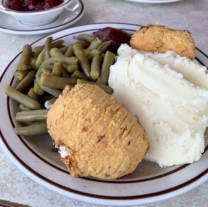 Comfort on a plate doesn't need to be complicated. Golden fried chicken, vibrant green beans, and cloud-like mashed potatoes—the holy trinity of diner perfection.