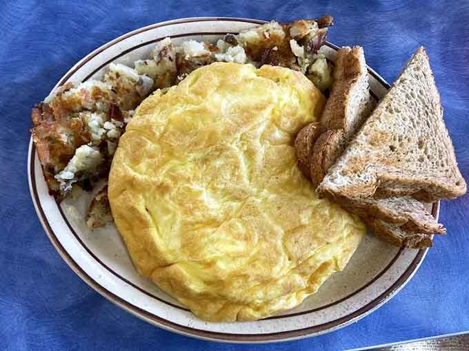 That fluffy omelet could double as a pillow, if pillows were delicious and came with hash browns.