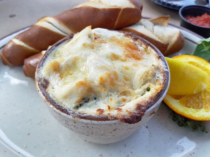 Behold the golden-topped crab dip, bubbling like a delicious volcano that's about to erupt all over your taste buds and ruin you forever.