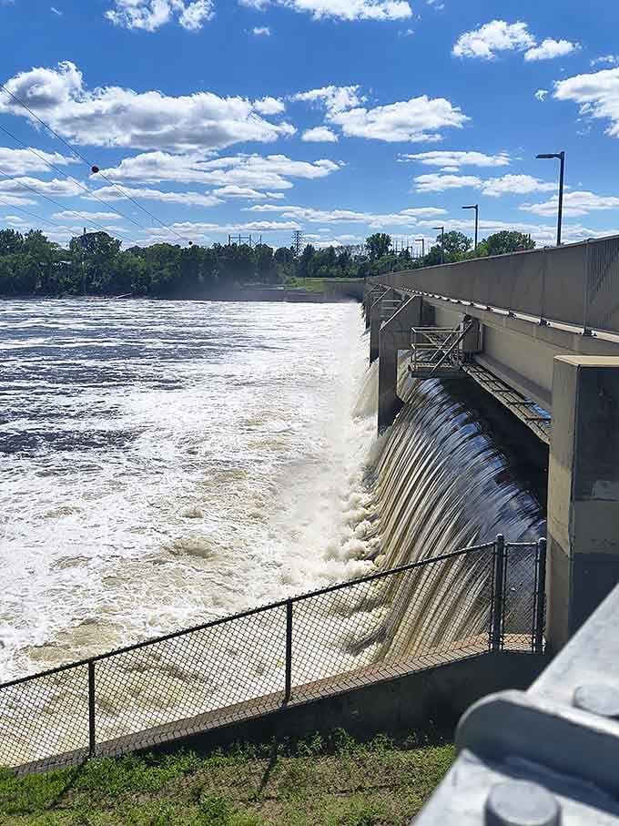 Even the utilitarian dam becomes photogenic when framed by blue skies and rushing water, proving infrastructure can have good angles.