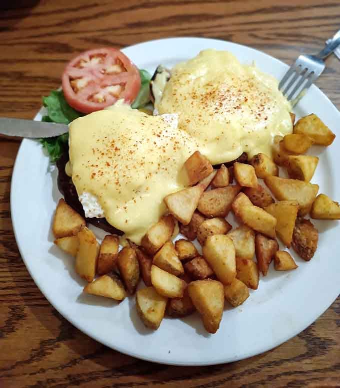 Eggs Benedict draped in hollandaise with crispy potatoes: this is what mornings were invented for.