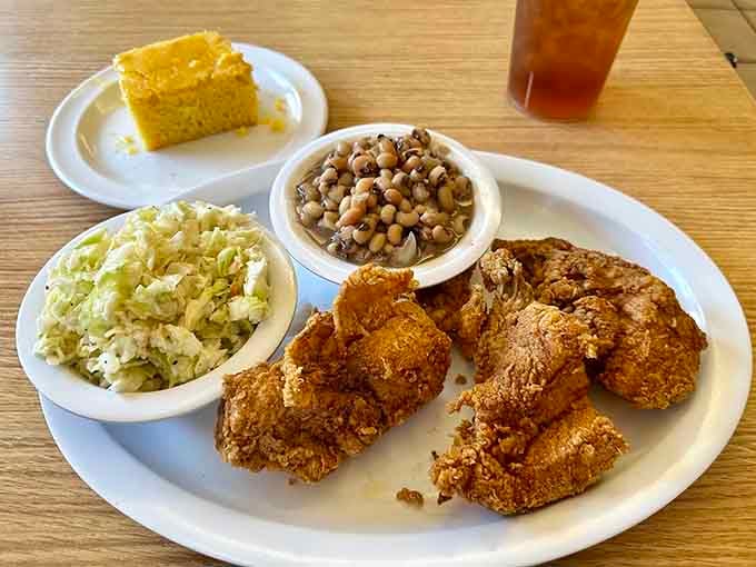 Golden fried chicken with black-eyed peas and cornbread: the holy trinity of soul food done absolutely right.