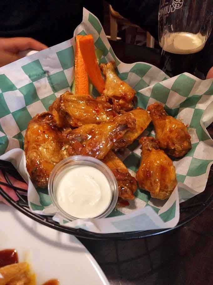Wings glazed to perfection, served with blue cheese and the kind of crunch that echoes through history.