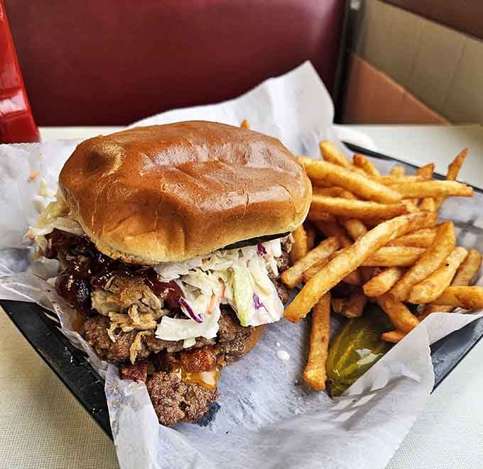 The Oasis Burger arrives with coleslaw piled high, because apparently someone decided burgers needed to get even better.