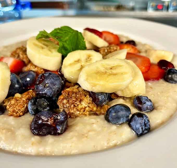 Oatmeal topped with fresh berries, bananas, and granola proves healthy eating doesn't have to taste like punishment.