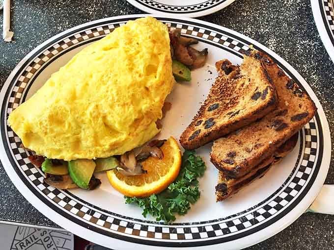 Behold the Western omelet in its natural habitat&mdash;perfectly folded, bursting with veggies, and flanked by raisin toast that's achieved that magical butter-soaked crispness.