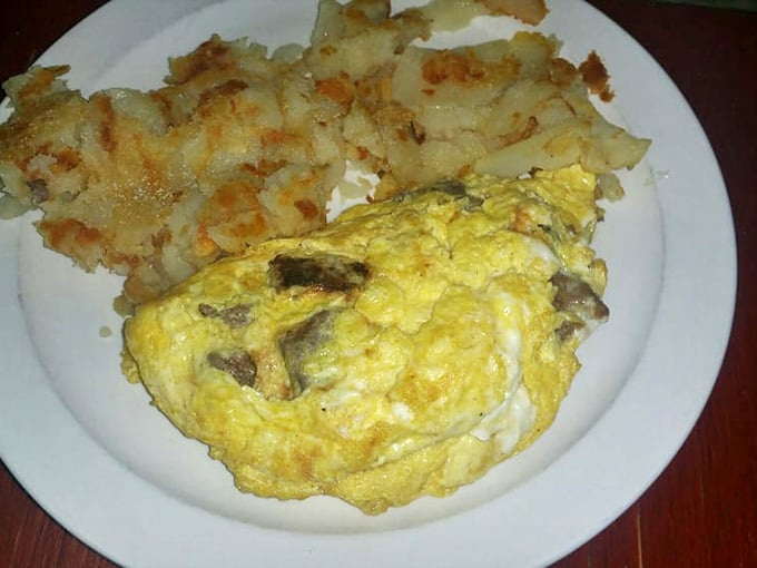 Behold the legendary omelet in its golden glory! Perfectly executed eggs embrace their fillings like long-lost friends, with crispy home fries standing guard.