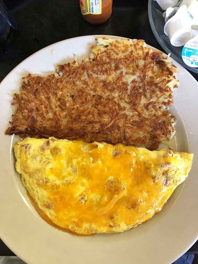 Golden hash browns meet a fluffy omelette in a partnership more successful than most celebrity marriages you've seen.