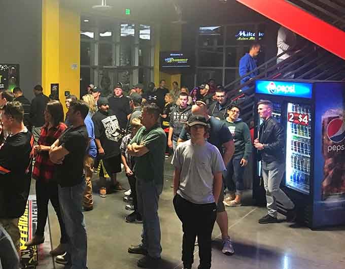 The pre-race energy here rivals a Beatles concert, except everyone's wearing helmets instead of screaming at mop-tops.