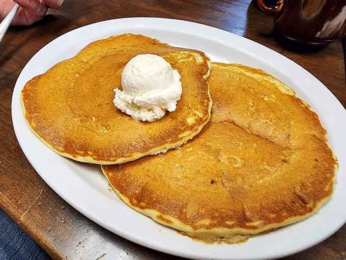 Golden pancakes topped with butter prove that simple done right beats fancy done wrong every time.