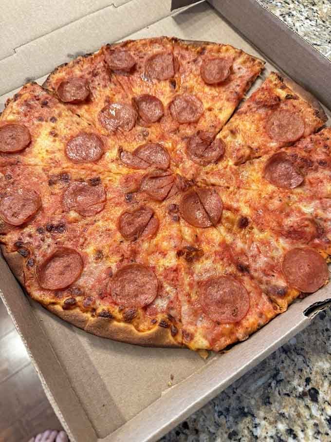 This isn't just pepperoni pizza; it's a masterclass in balance. Each cup of pepperoni creates a tiny pool of flavor that infuses the thin, crispy crust.