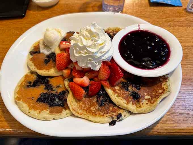 Blueberry pancakes topped with strawberries and whipped cream prove that sometimes more is definitely more, especially at breakfast.