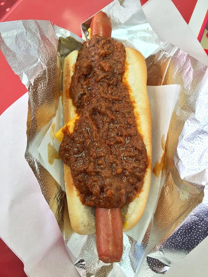 The classic chili cheese dog arrives looking exactly like your dreams promised it would taste.