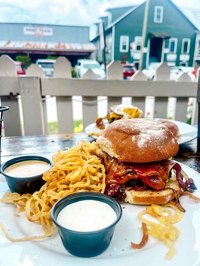 This towering masterpiece comes with crispy fries and enough bacon to make your cardiologist write poetry about mortality.