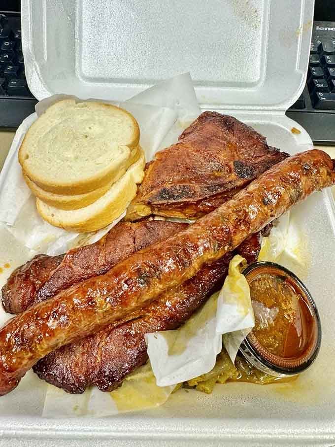 BBQ pork steak and sausage that would make angels weep, served with bread for sopping up every last drop of that heavenly sauce.