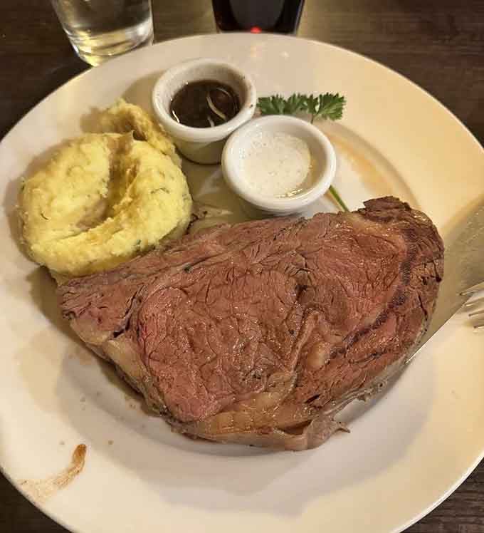 Behold the star of the show: perfectly pink prime rib accompanied by garlic mashed potatoes and those two magical elixirs&mdash;au jus and horseradish sauce.